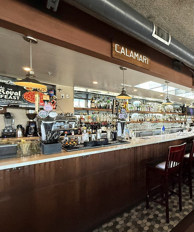 The bar area buzzes with coastal energy where stories flow as freely as the wine.