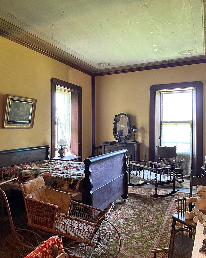 This bedroom suite features a cradle and wicker baby carriage&mdash;childcare solutions from an era when "sleep training" meant hoping for the best.