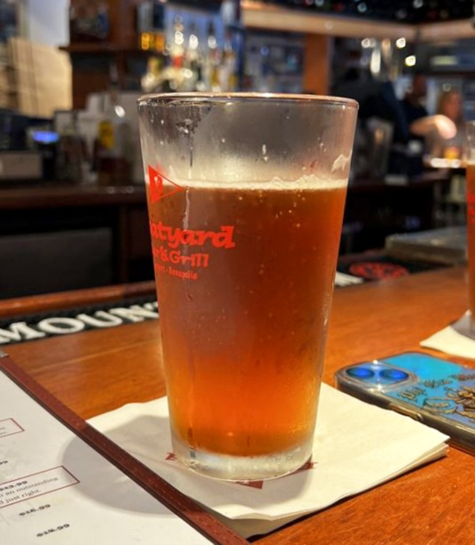 A perfectly poured beer in branded glassware catches the light at the bar – liquid amber that promises to be the ideal companion to seafood delights.