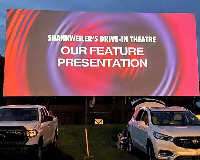 "Our Feature Presentation"—four words that still trigger Pavlovian excitement. The screen glows like a beacon in the twilight, drawing everyone's gaze.