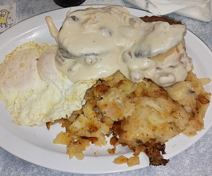 Biscuits and gravy with a side of eggs&mdash;where comfort food meets artistic expression in a symphony of savory that makes your fork the conductor.