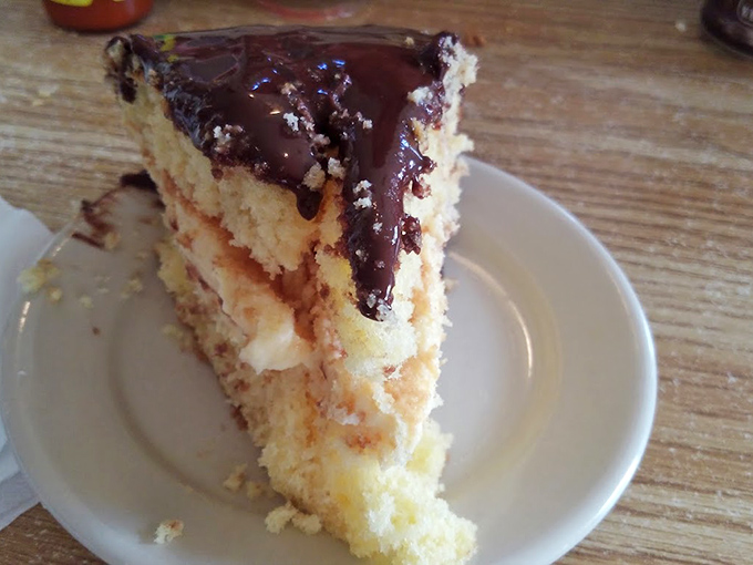 Layer upon layer of sweet conspiracy&mdash;this Boston cream cake isn't just dessert, it's proof that happiness can be served on a small white plate.