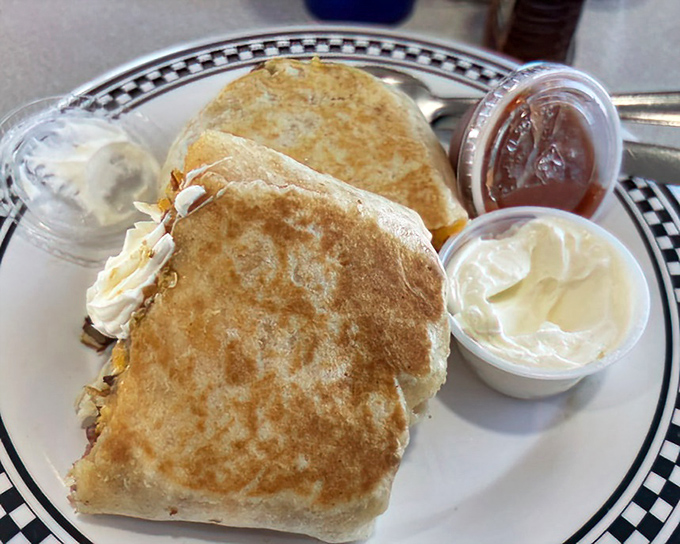 Breakfast burritos: where morning ingredients find their perfect home wrapped in a warm tortilla blanket with condiment companions.