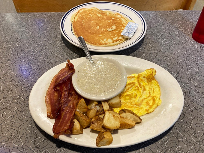 The breakfast platter that launched a thousand food comas: pancakes, bacon, eggs, and home fries.