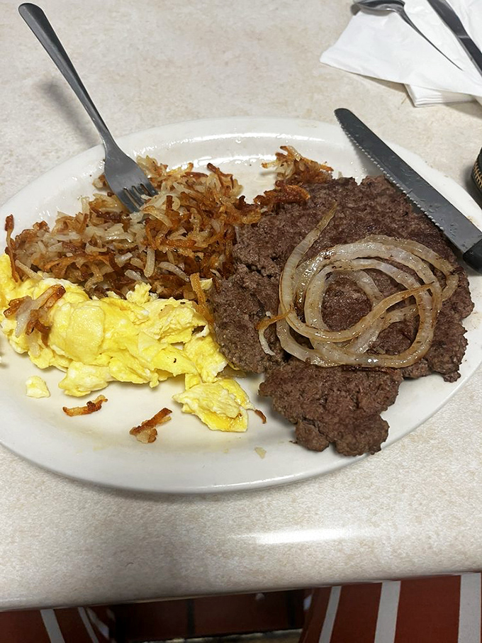 The classic hamburger steak platter&mdash;where eggs and meat unite in a breakfast symphony that would make your cardiologist wince and your taste buds applaud.