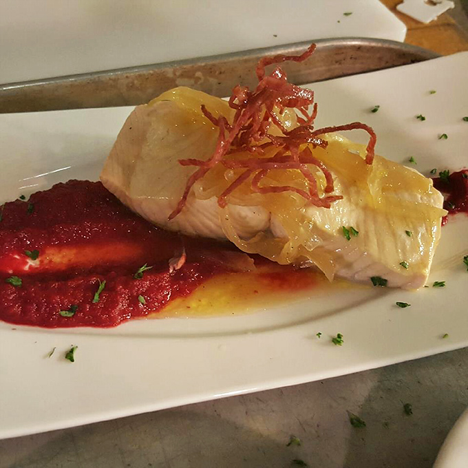 Delicate fish resting on a vibrant sauce isn't just dinner—it's evidence that classic establishments can still surprise your taste buds.