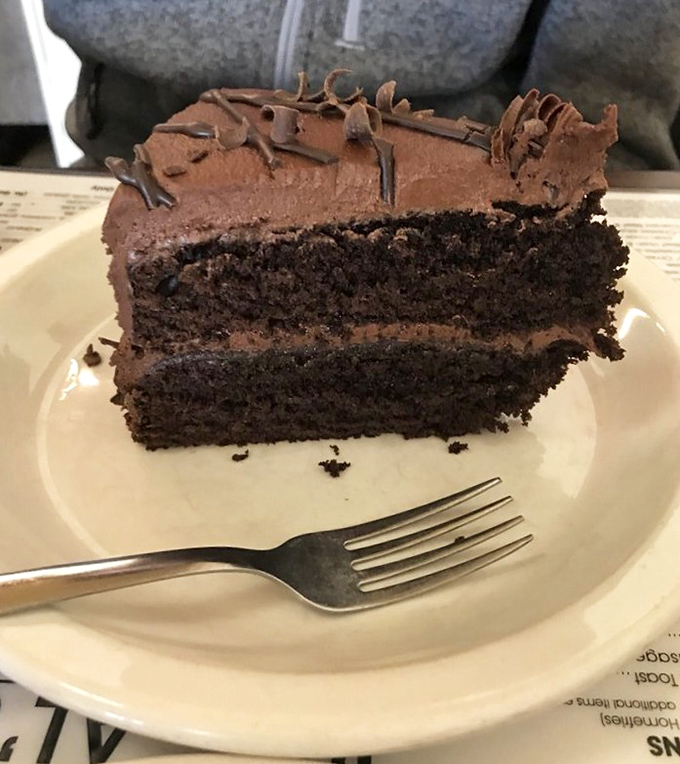 Chocolate cake so rich it should have its own tax bracket. Fork required, sharing optional but not recommended.