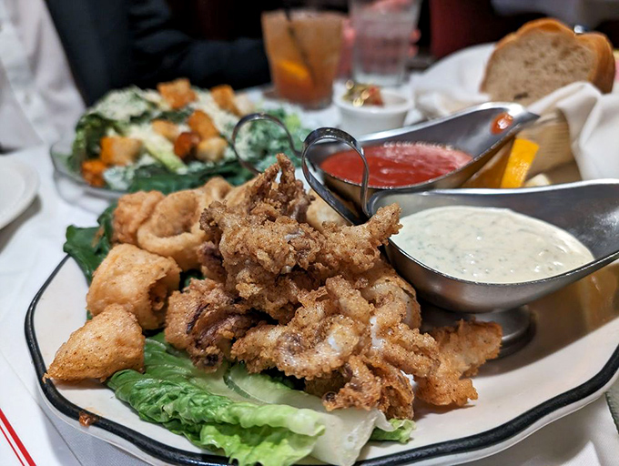 Crispy calamari that shatters between your teeth, served with dipping sauces worth fighting over.