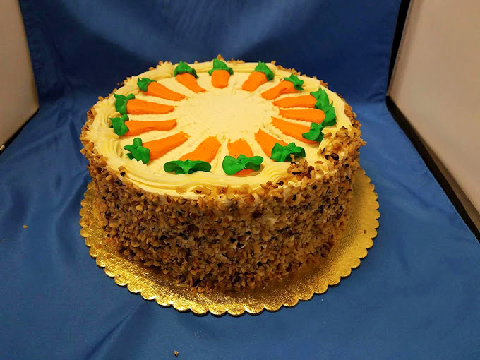 This carrot cake wears its cream cheese frosting like a crown. Those decorative carrots aren't fooling anyone&mdash;this is dessert, gloriously unapologetic.