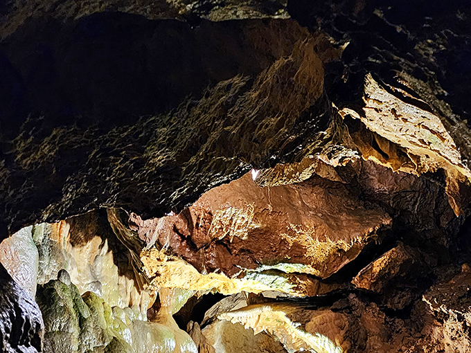 Shadows and light play across ancient rock formations, revealing colors and textures that seem almost alien in their otherworldly beauty.
