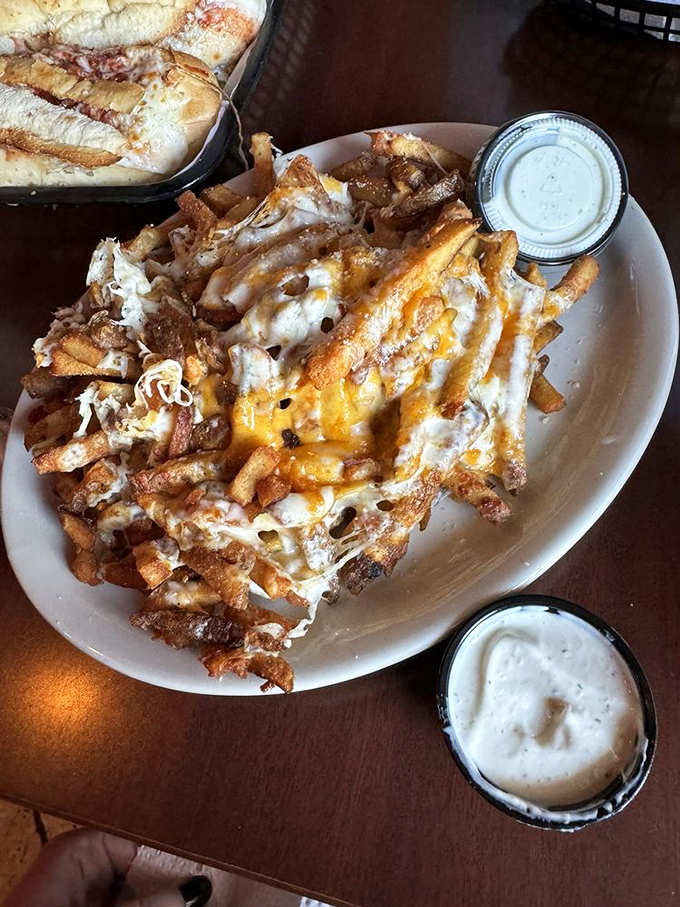Cheese fries elevated to an art form. That melty blanket covering hand-cut potatoes isn't just a side dish&mdash;it's what dreams are made of.
