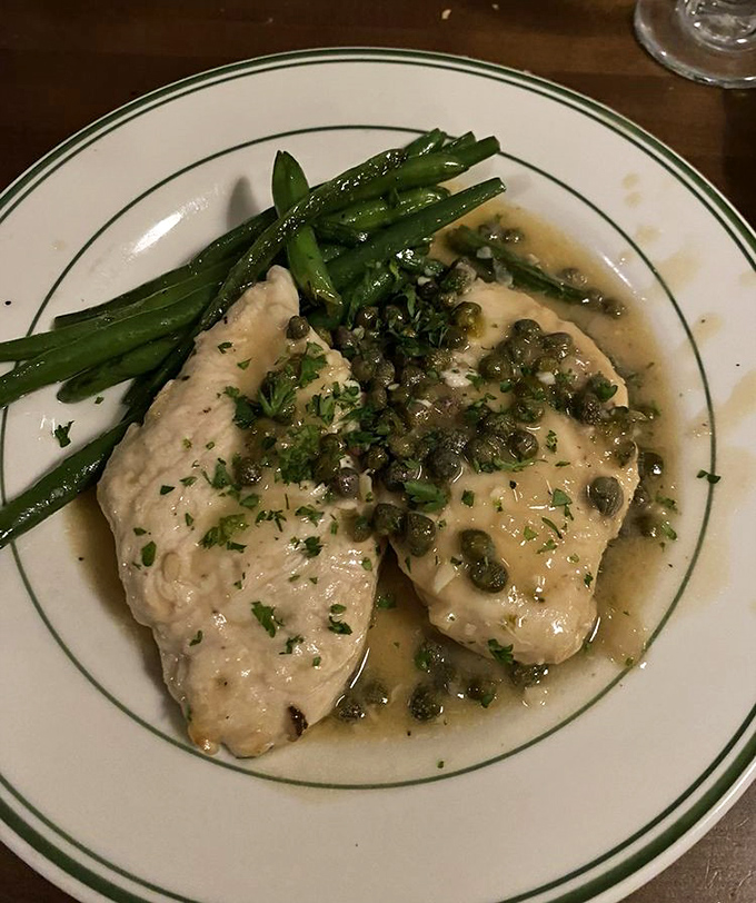The bar area where industrial meets inviting. Those hanging glasses aren't just practical&mdash;they're chandeliers for the cocktail crowd.