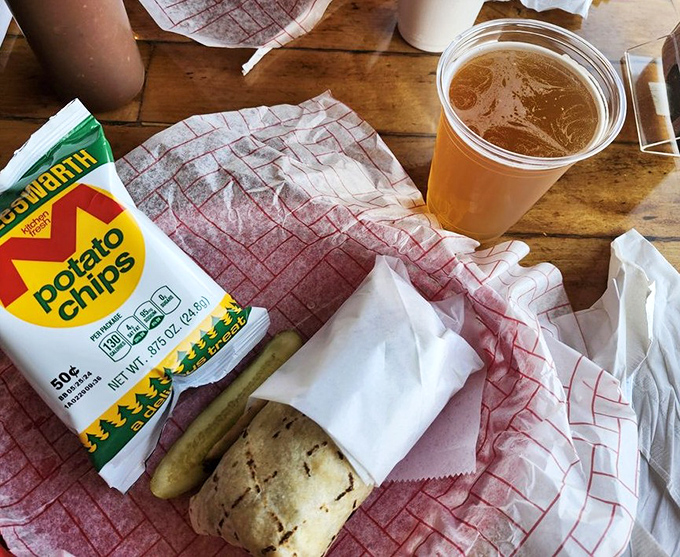 Simple pleasures: cold beer, potato chips, and something wrapped in paper that promises deliciousness. Sometimes happiness comes in humble packaging.