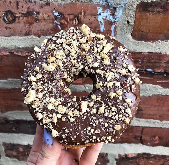 Chocolate hazelnut donut with crushed nuts&mdash;proof that plant-based eating can be indulgent, sophisticated, and utterly irresistible.