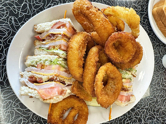 The club sandwich—architecture you can eat, with layers of satisfaction held together by toothpick engineering.