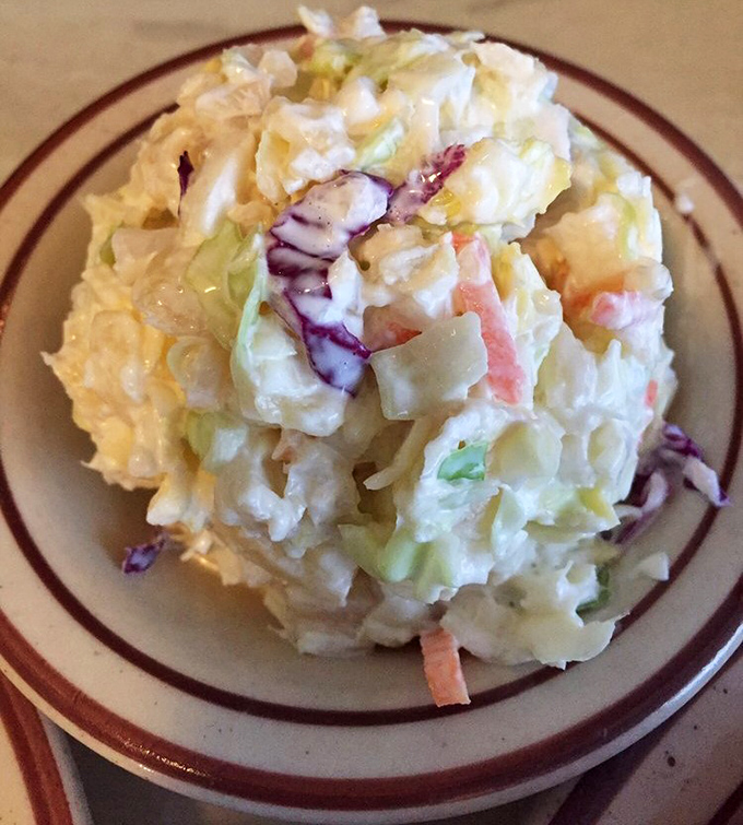 This isn't just coleslaw—it's a creamy, crunchy masterpiece. The perfect cool counterpoint to hot fried chicken, with bits of colorful vegetables peeking through like confetti.