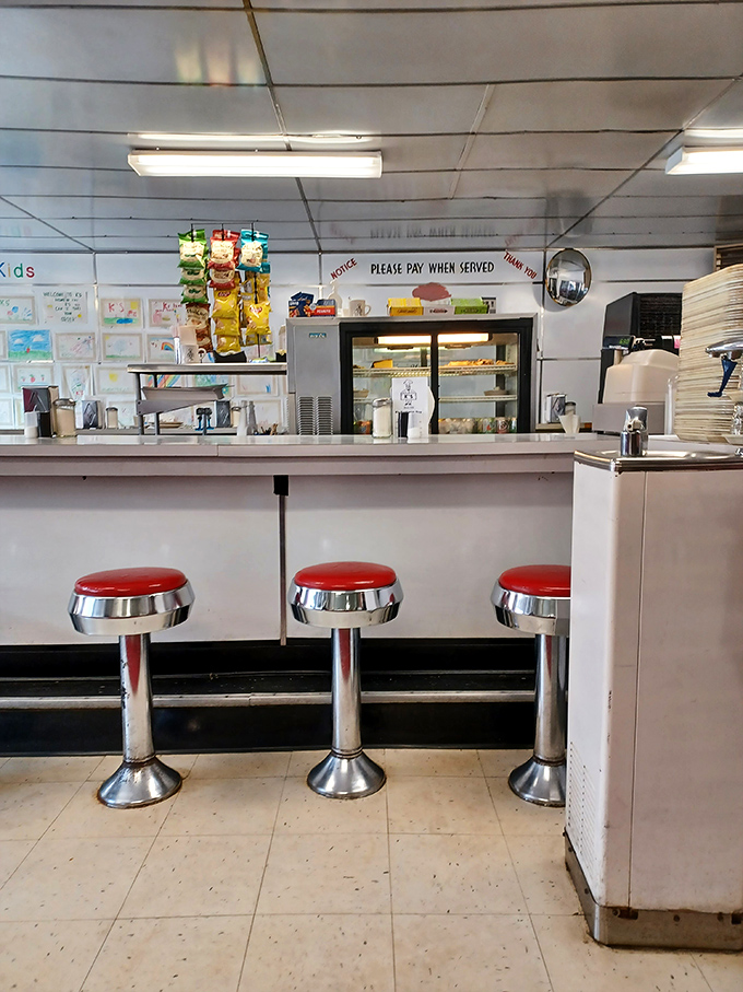 Classic counter seating where culinary dreams come true. These red stools have witnessed first dates, business deals, and countless "I'll just have one more bite" moments.