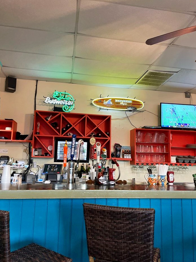 The bar's bright coral shelving and turquoise paneling scream "Florida!" without a single plastic flamingo in sight. Beach casual done exactly right.