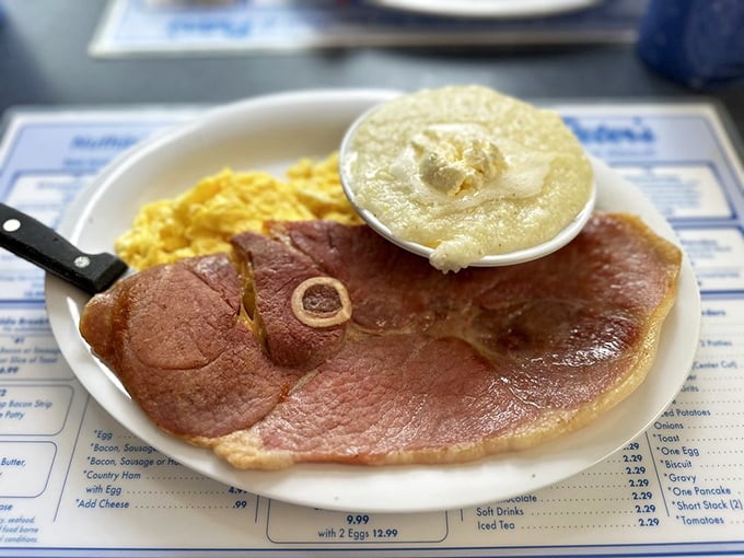 Country ham that's been cured to perfection alongside creamy grits. This plate represents centuries of Southern breakfast tradition in one glorious serving.