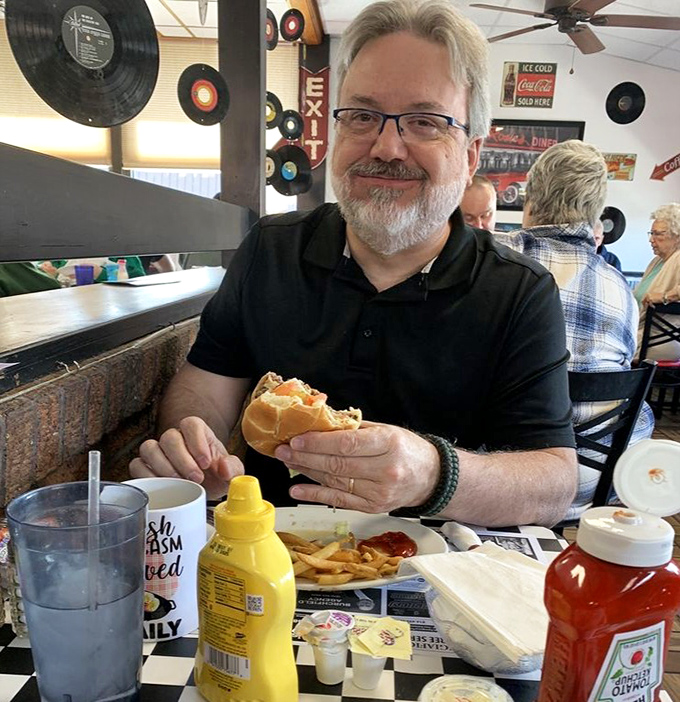 The diner's unofficial mascot can't help smiling&mdash;he's halfway through a burger that makes fast food chains look like they're not even trying.