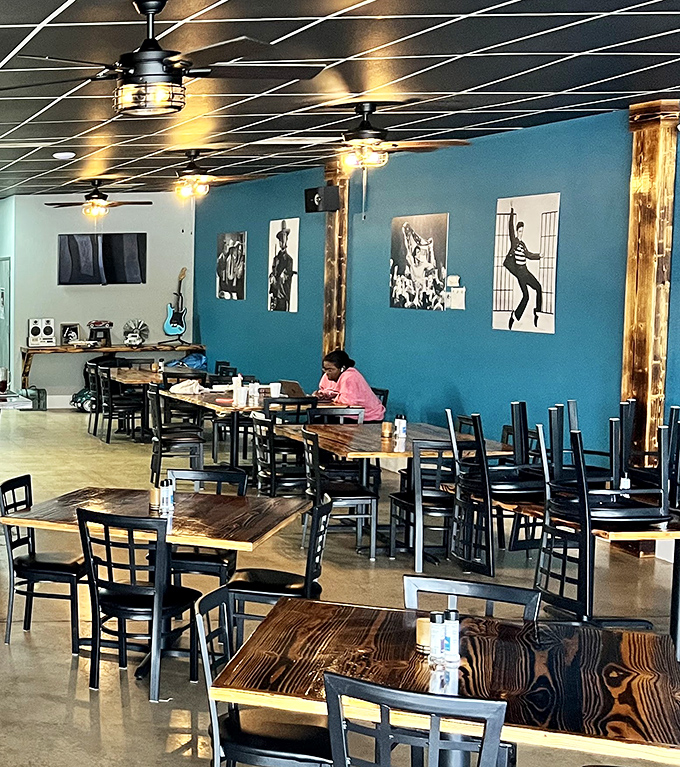 The dining room's blue walls adorned with iconic black and white photographs create an atmosphere that's both nostalgic and thoroughly modern.