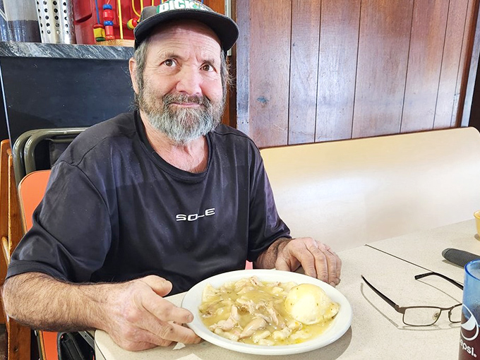 A satisfied diner enjoying the simple pleasure of perfectly executed comfort food&mdash;his expression says what words cannot.