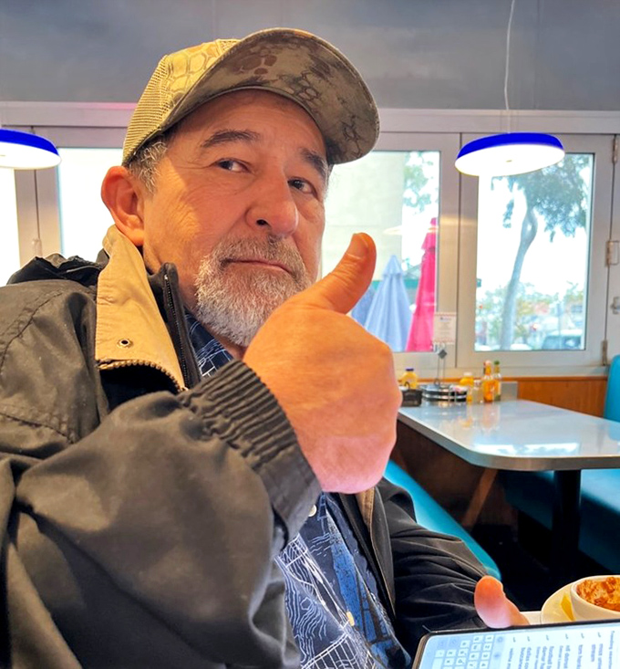 One happy customer giving the universal sign for "Yes, this place absolutely delivers on its promises."