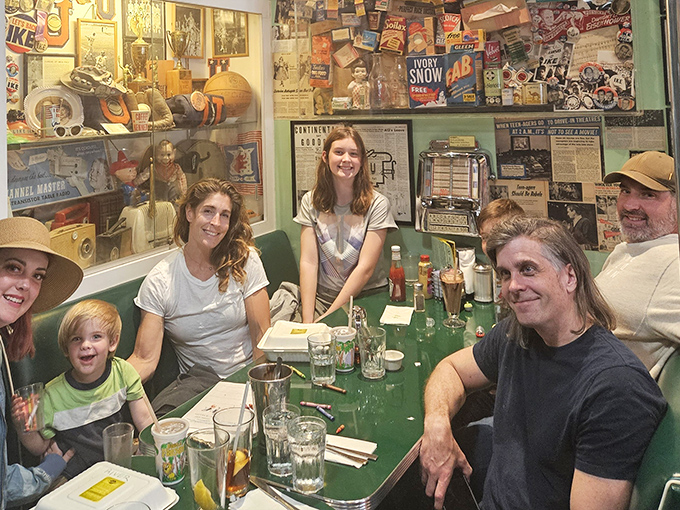 Every booth tells a story, but this one's writing a whole family chapter. The vintage memorabilia wall makes everyone feel like a time traveler.