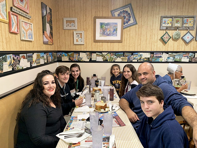 Happy diners enjoying the kind of meal that turns strangers into friends over shared appreciation for excellence.