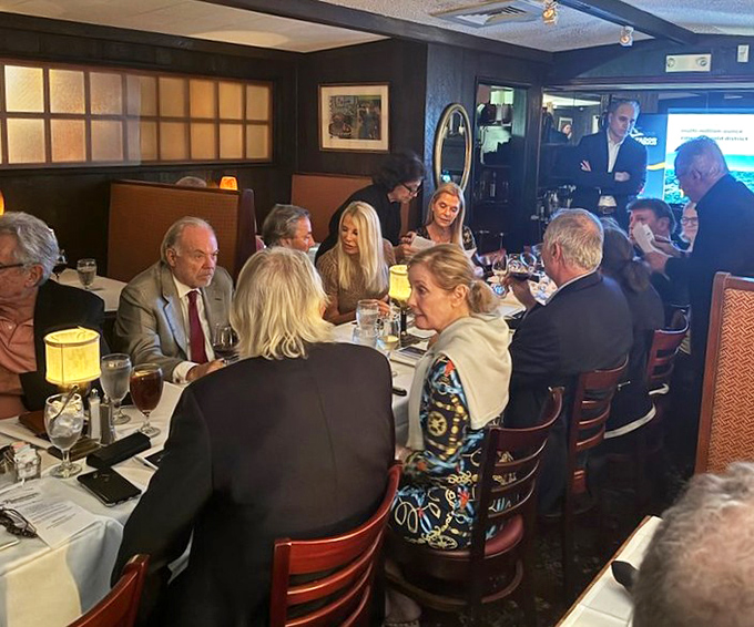 Happy diners gathered around tables, proving that great food creates the kind of memories worth driving for.
