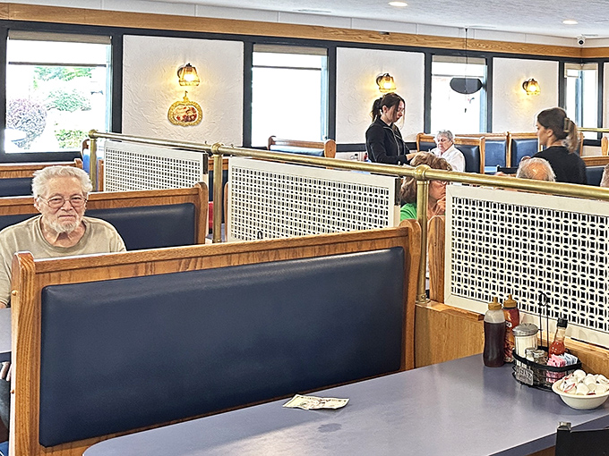 The booth dividers create little neighborhoods within the restaurant, where strangers become temporary neighbors united by good food.