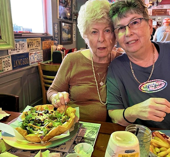Happy diners sharing salads and stories prove that good food creates the kind of connections money can't buy.
