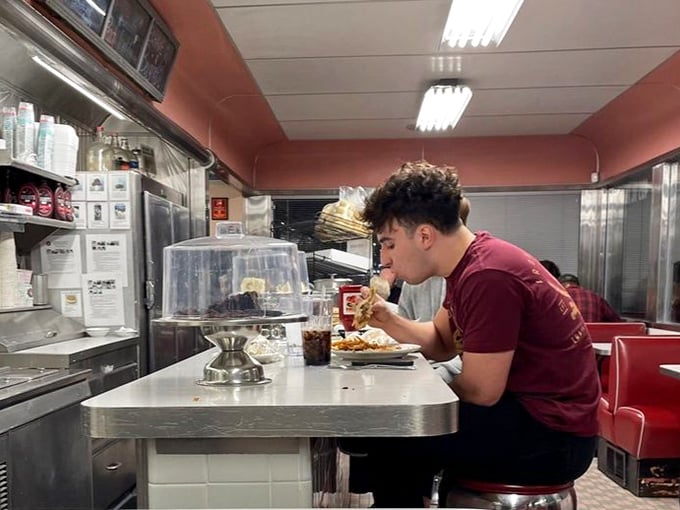 Counter dining: where strangers become temporary neighbors united by the universal language of "pass the ketchup, please."