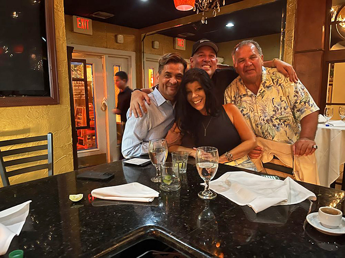 Happy diners sharing stories and laughter over good food—the universal language that needs no translation, just extra napkins and maybe another round.