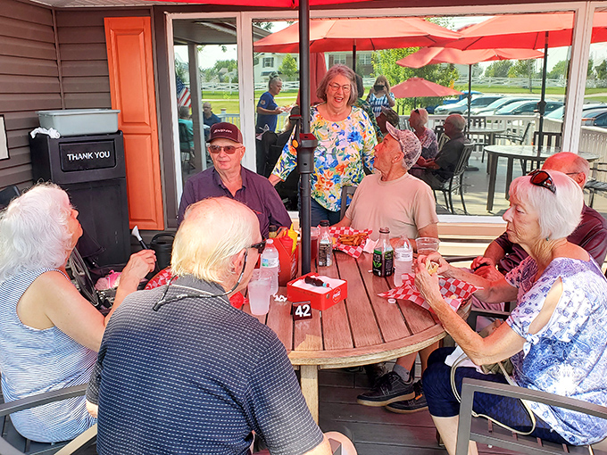 Where generations gather to share stories and spectacular food. The outdoor patio: where strangers become friends over the universal language of hot dogs.