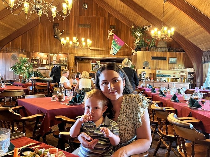 The vaulted wooden ceiling and warm lighting create a dining room that feels like a Northwoods cathedral dedicated to the religion of good eating.