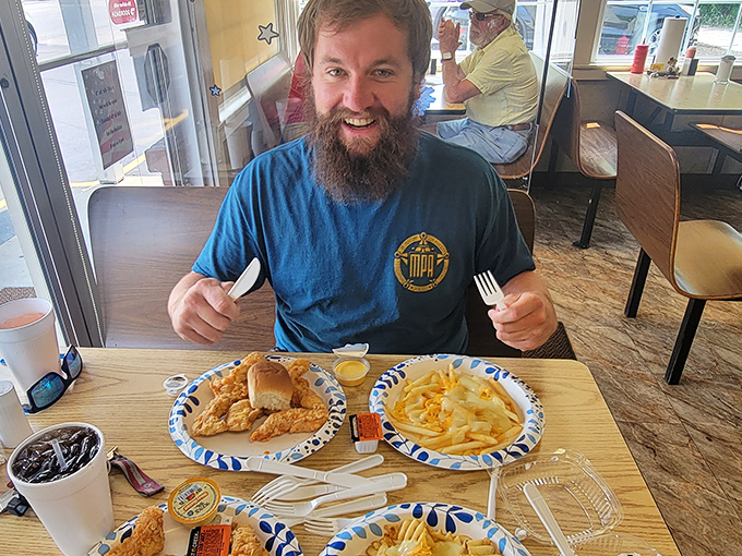The universal expression of a man about to experience fried chicken nirvana. Those plastic forks don't know the honor they're about to receive.