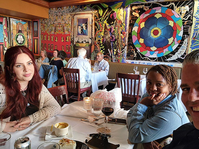 The colorful artistic backdrop creates the perfect setting for celebrations, first dates, or Tuesday night dinners that feel like special occasions.