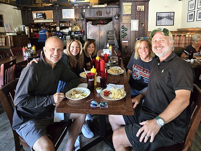 Happy diners sharing stories and meals &ndash; the universal language of good food bringing people together around a wooden table.