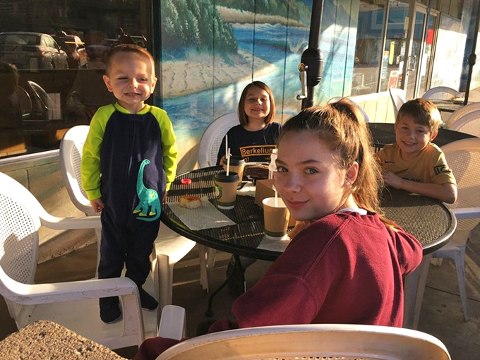 Kids plus sugar equals pure joy&mdash;this outdoor table captures the universal truth that donuts are happiness delivery devices.