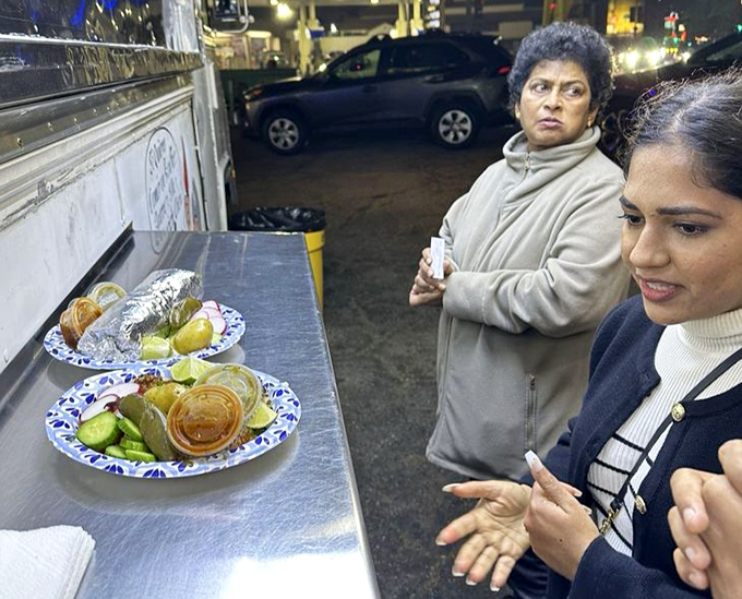 The metal counter becomes an impromptu dining room where strangers become temporary friends united by the universal language of "mmmmm."