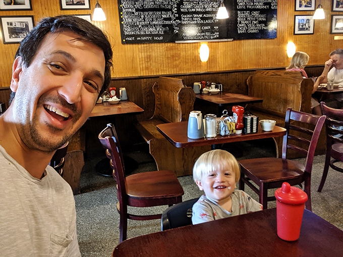 Father and son sharing a meal – where memories are made one bite at a time.