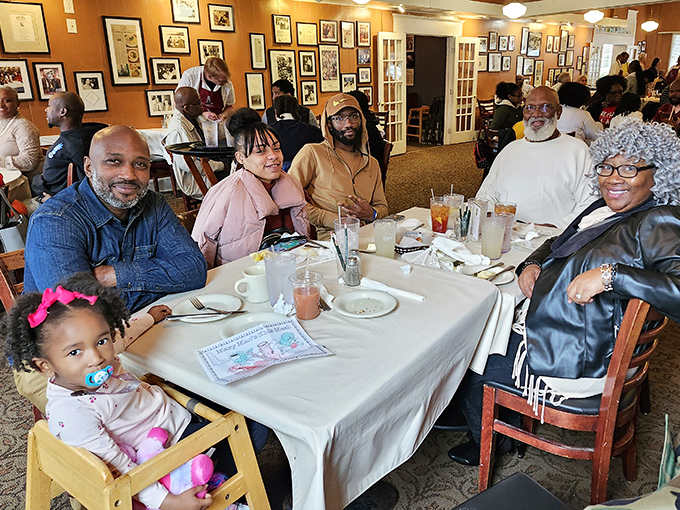 Multi-generational families gather around white-clothed tables, creating memories that will outlast the meal itself.