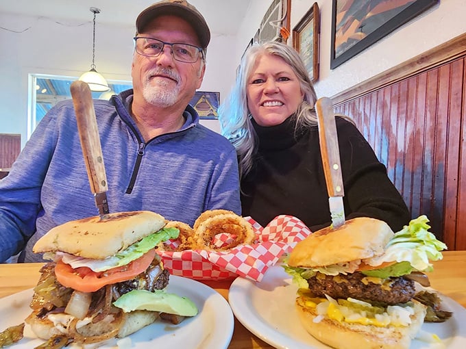 Happy diners with burgers bigger than their smiles. When knives are required for a sandwich, you know you're in the right place.