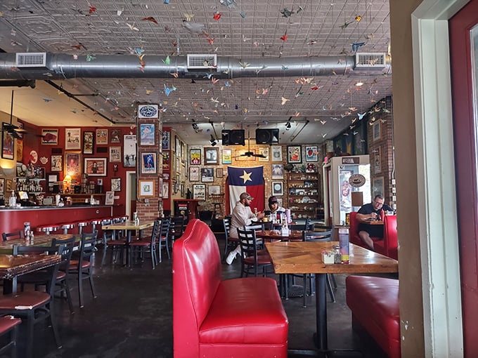 Red booths, memorabilia-covered walls, and the warm buzz of conversation create the kind of atmosphere where strangers become friends over shared plates.