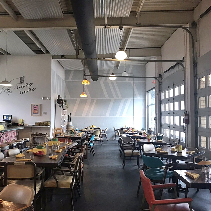 Garage doors and industrial ceilings create an airy canvas for culinary creativity, proving great food doesn't need white tablecloths to be extraordinary.