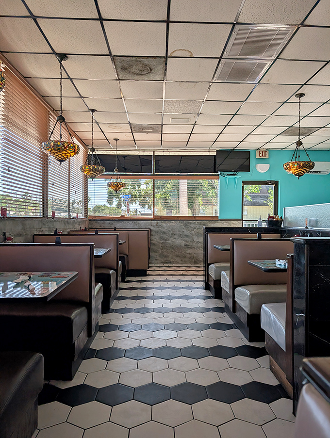 Classic diner geometry: hexagonal floor tiles leading to rectangular booths under square ceiling panels. Comfort food served in a comfort zone.