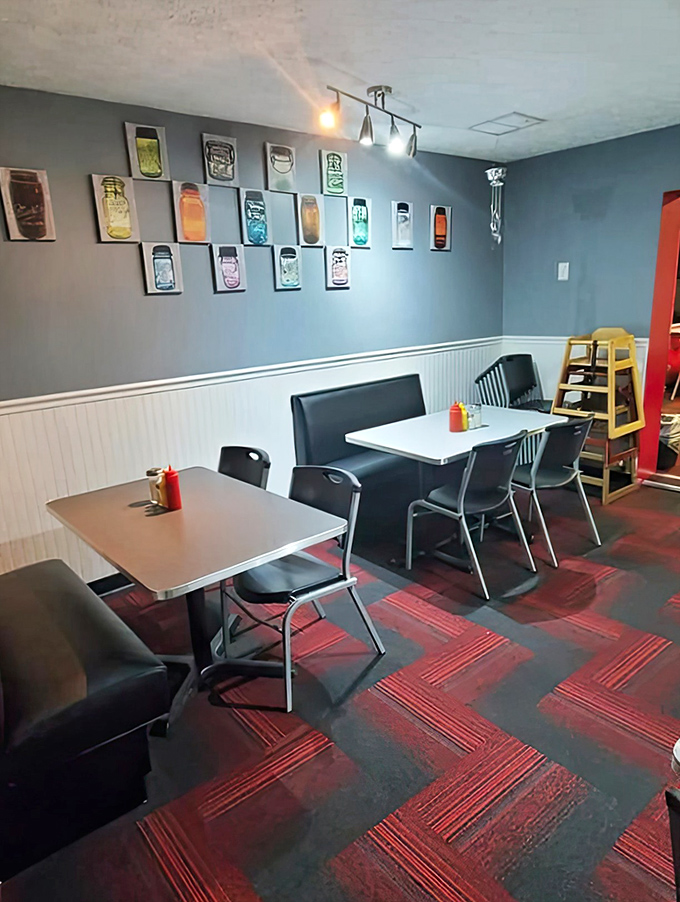 Mason jar art watches over diners like colorful guardians of good taste in this dining area where the red carpet treatment starts with the floor.