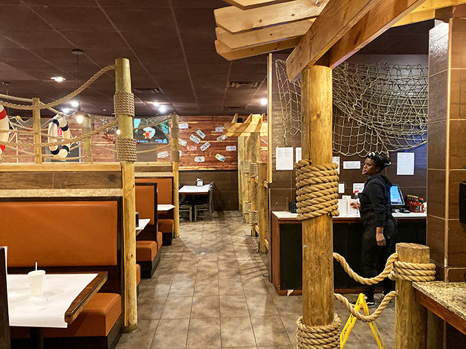 The dining area continues the nautical theme, with wooden beams and booth dividers that feel like you're dining aboard a well-appointed ship.