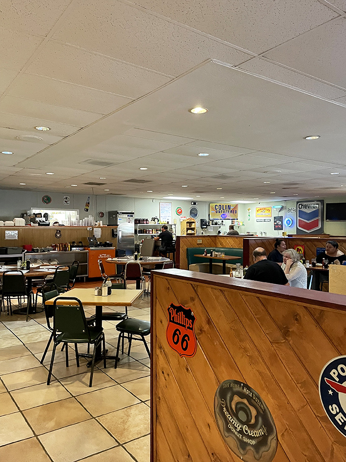 Vintage gas station signs and wooden dividers create an atmosphere where nostalgia isn't manufactured&mdash;it's earned through decades of consistent comfort.